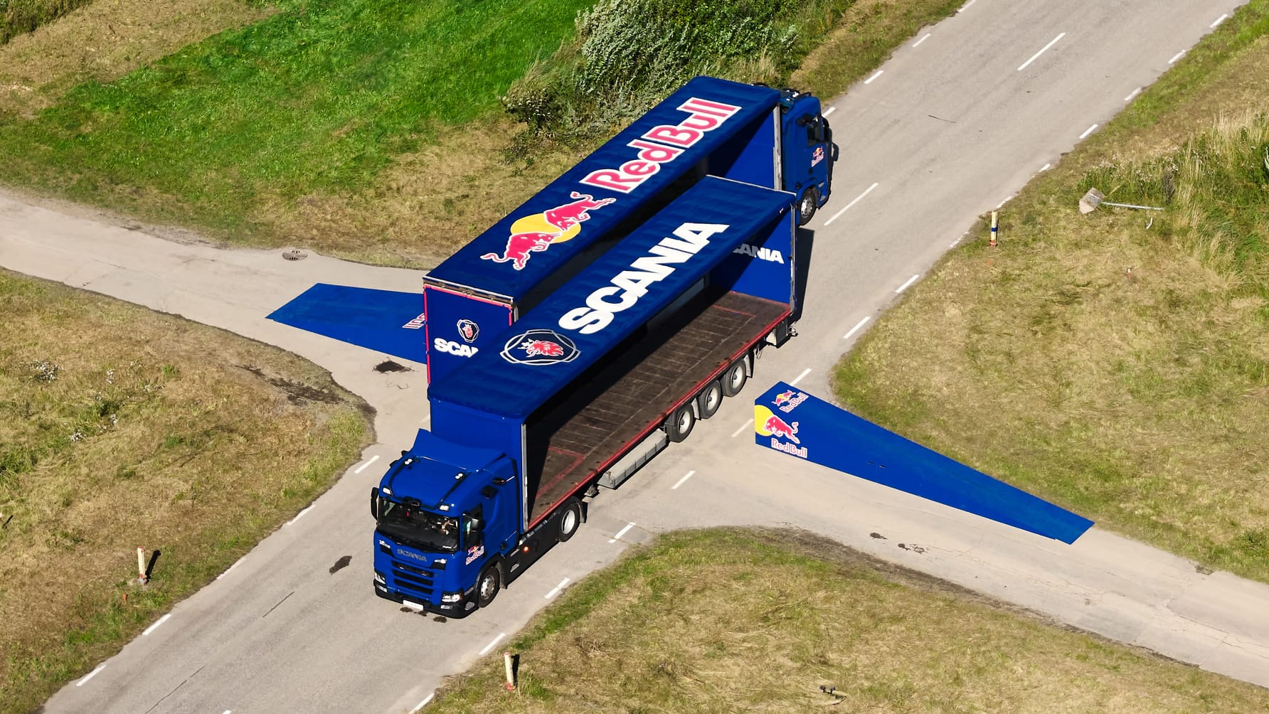A mountain biker has jumped through the middle of two moving self ...
